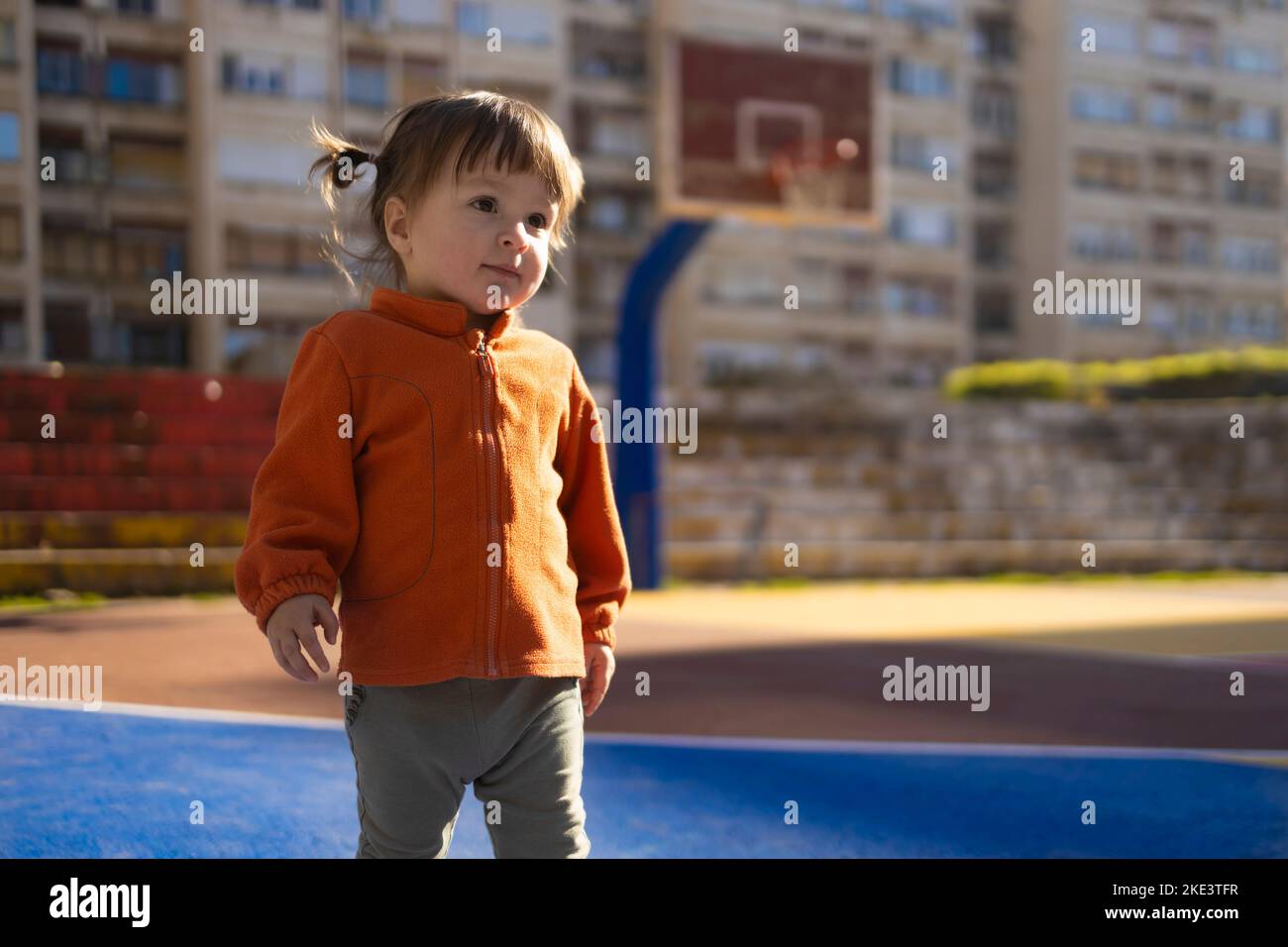 Small female child playing on the basketball court Stock Photo - Alamy