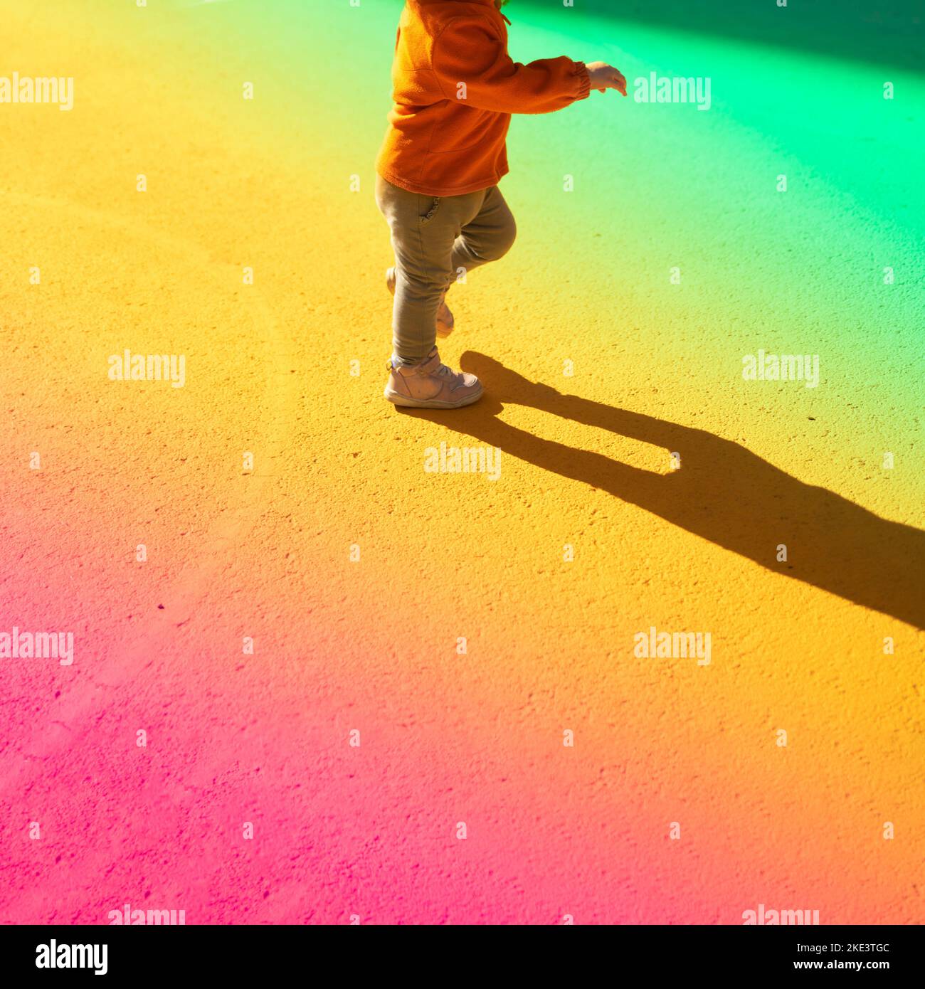 Child playing and running on a colorful playground Stock Photo - Alamy