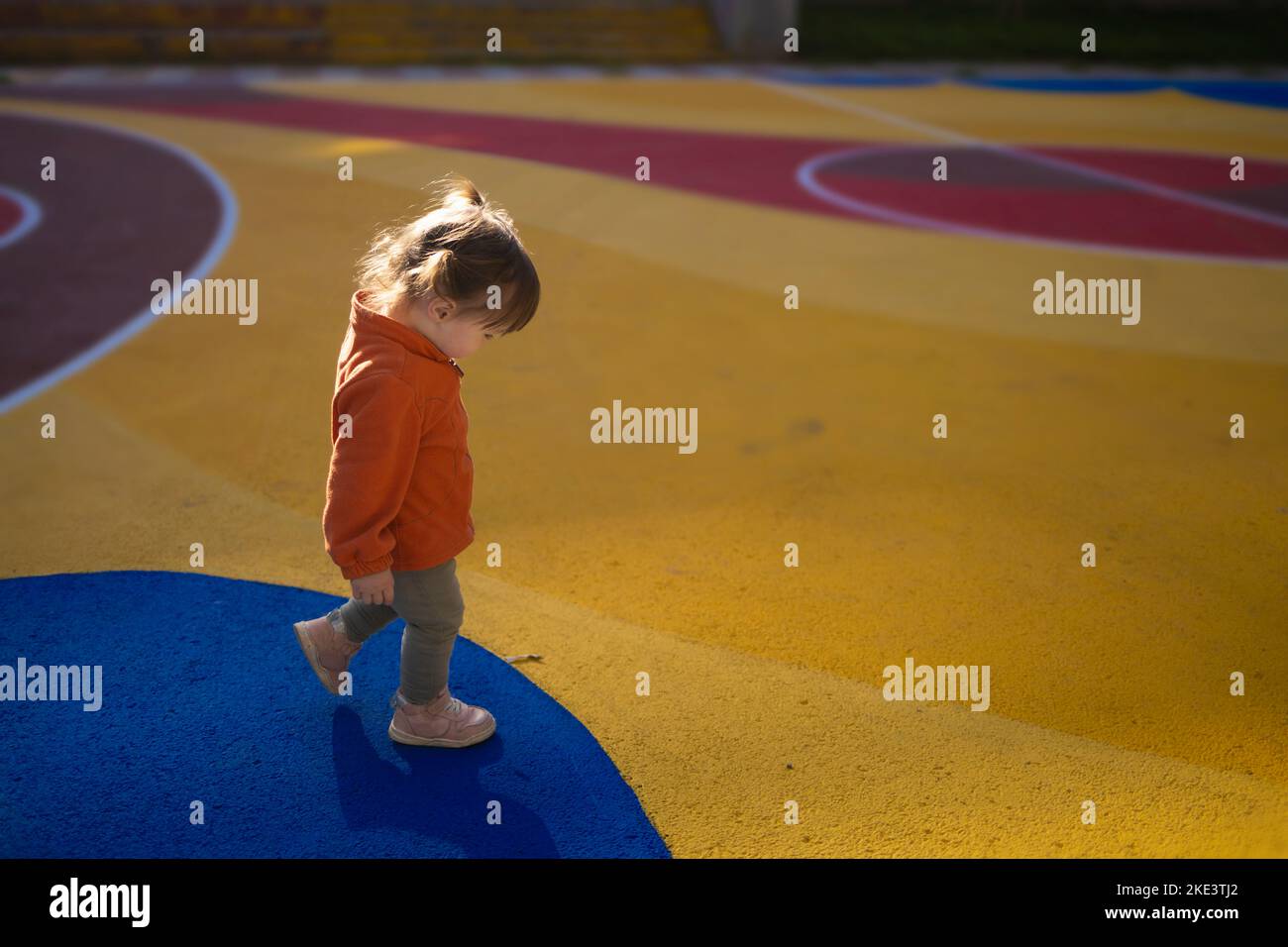 Little child playing on a basketball counrt Stock Photo - Alamy