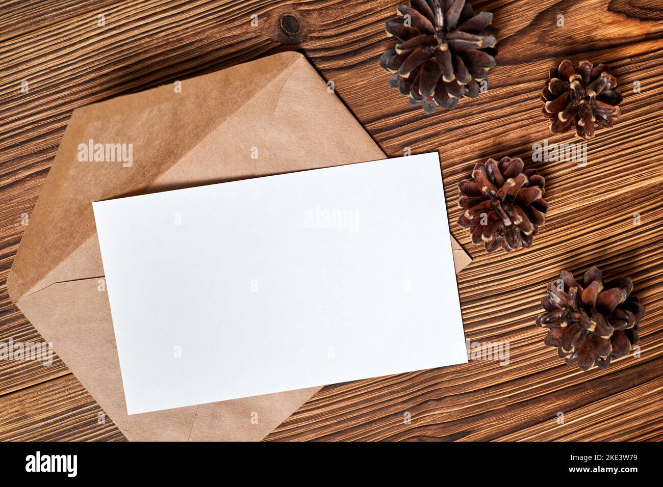 Open envelope with blank letterhead on wooden background with Pine ...