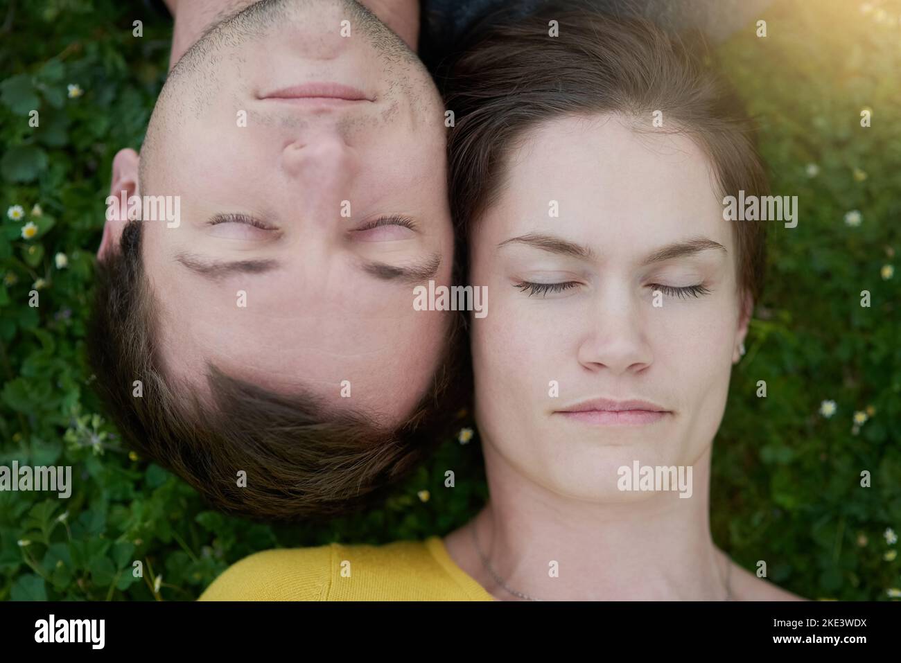 Love is in their nature. a young couple lying with their heads together ...