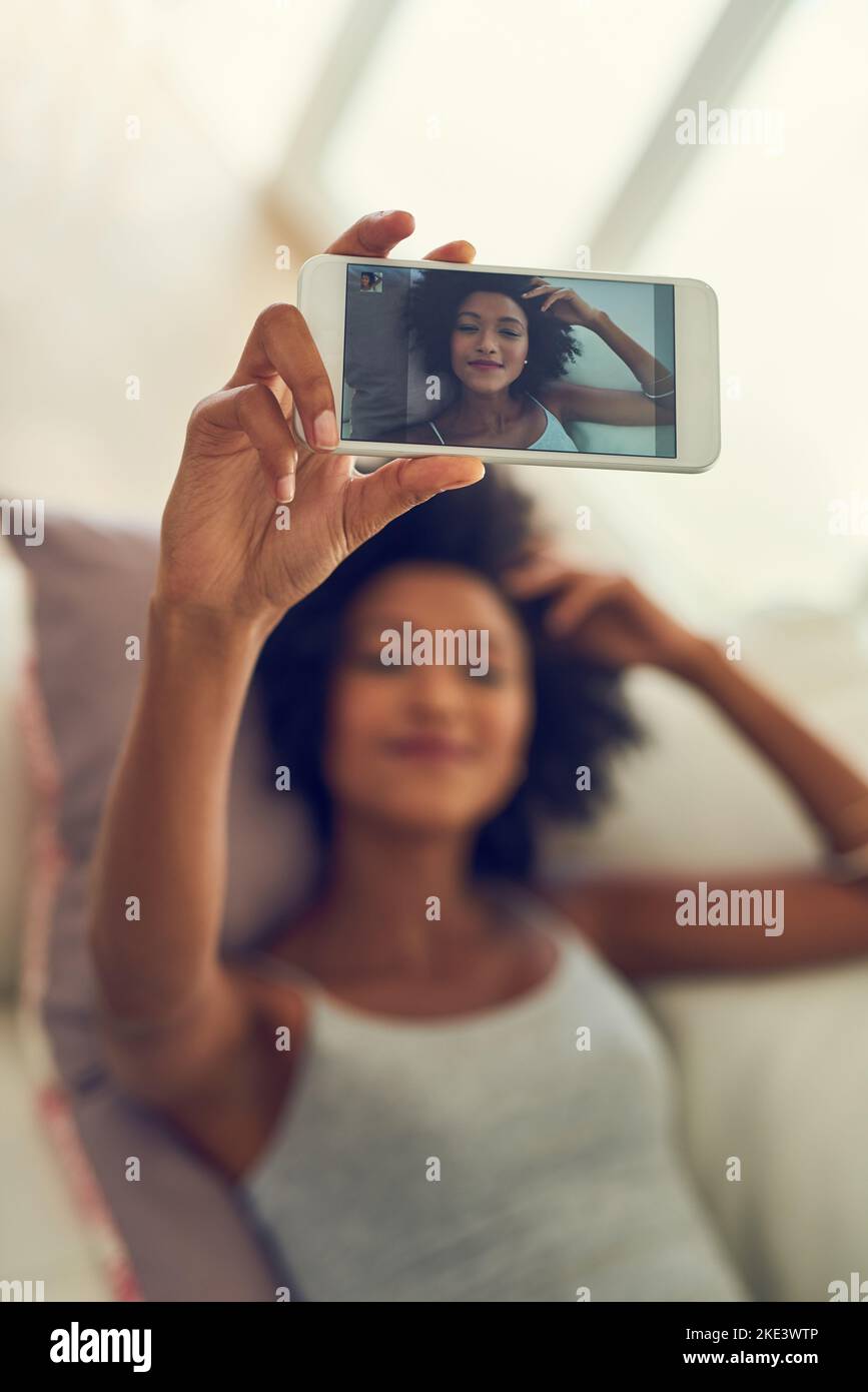 She knows how to take the perfect selfie. a young woman taking a photo ...