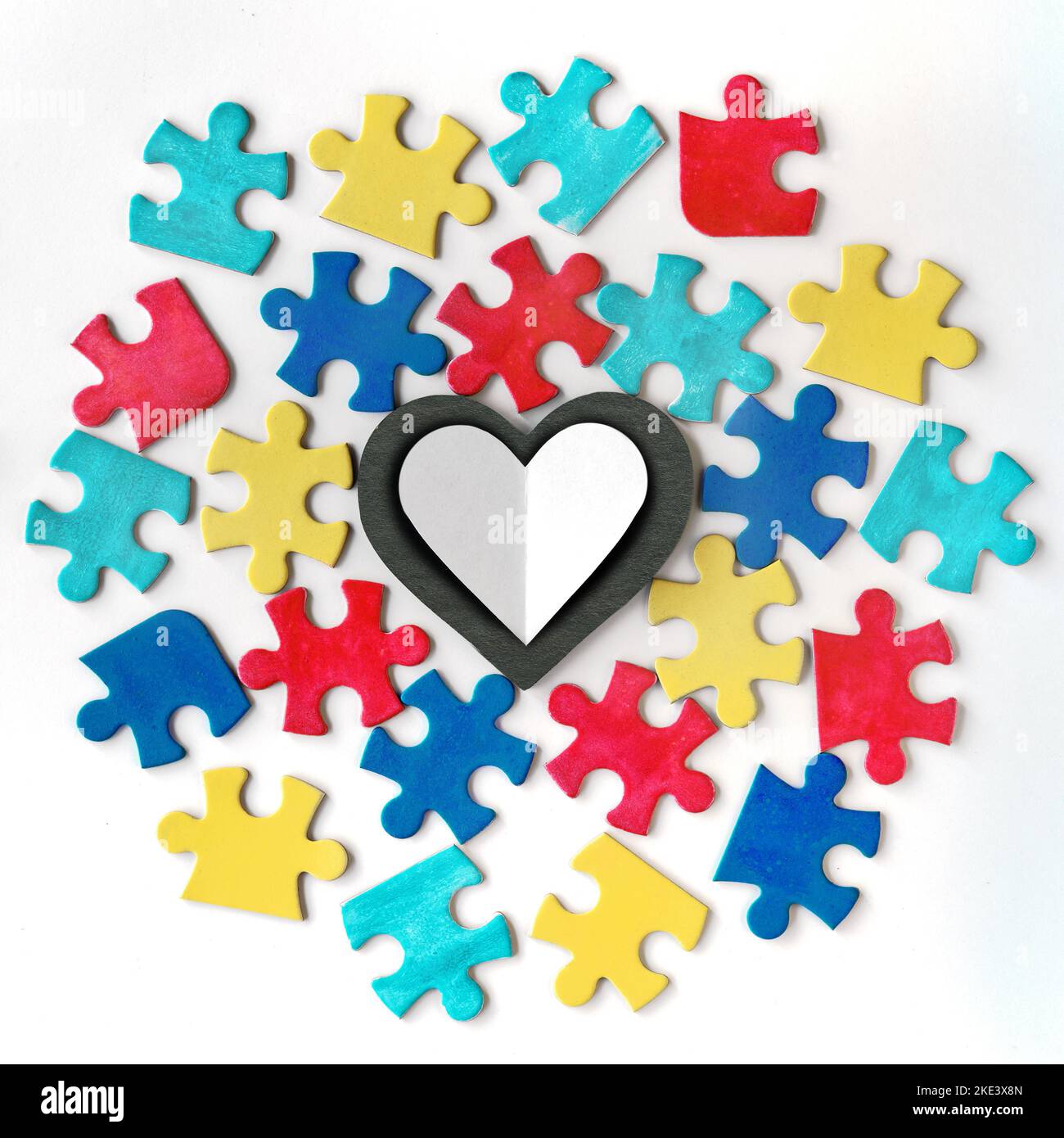 Autism campaign symbols. Colorful puzzle pieces around blackboard stone ...