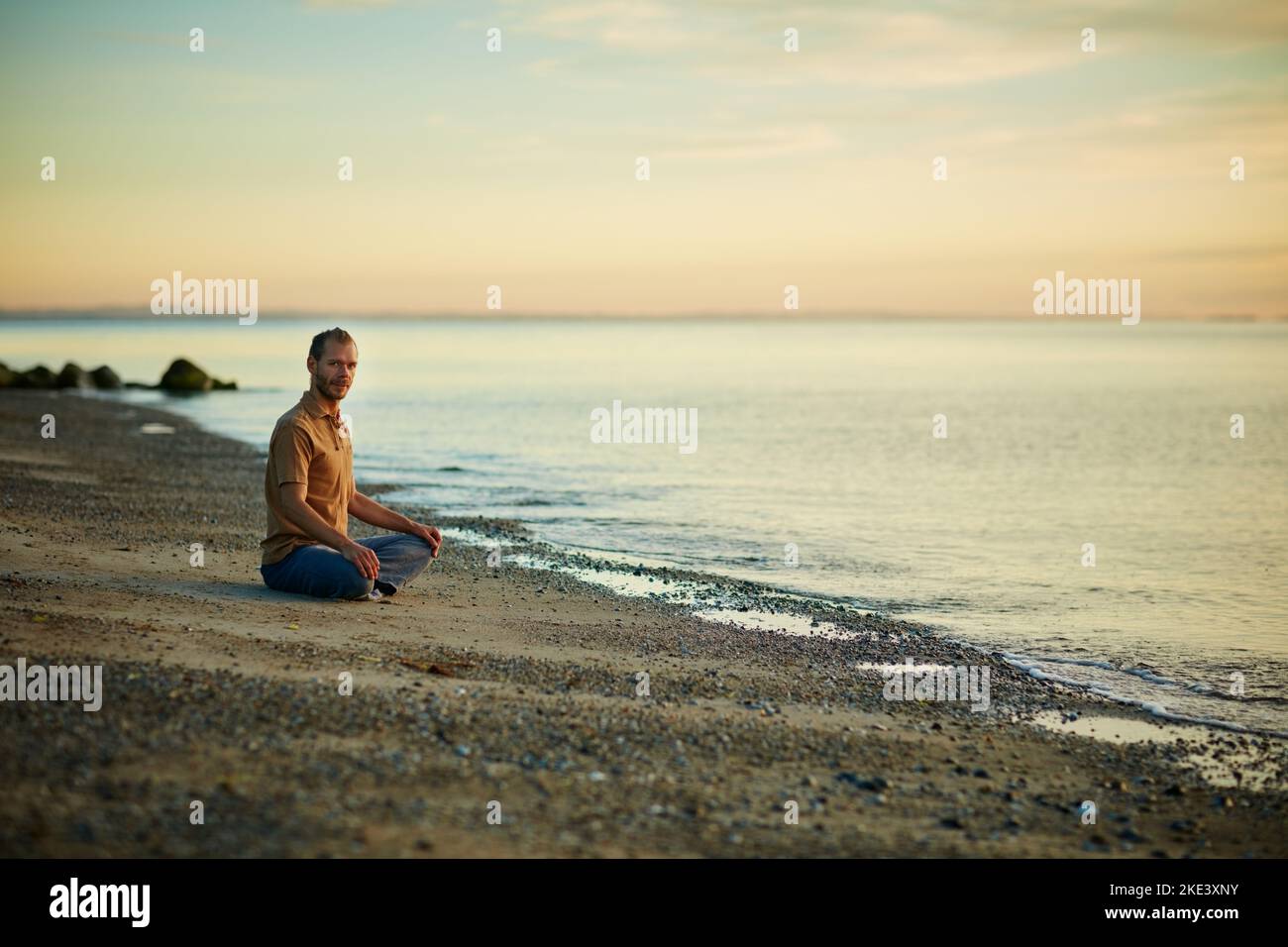 Yoga heals the soul. a man sitting in the lotus position during his ...