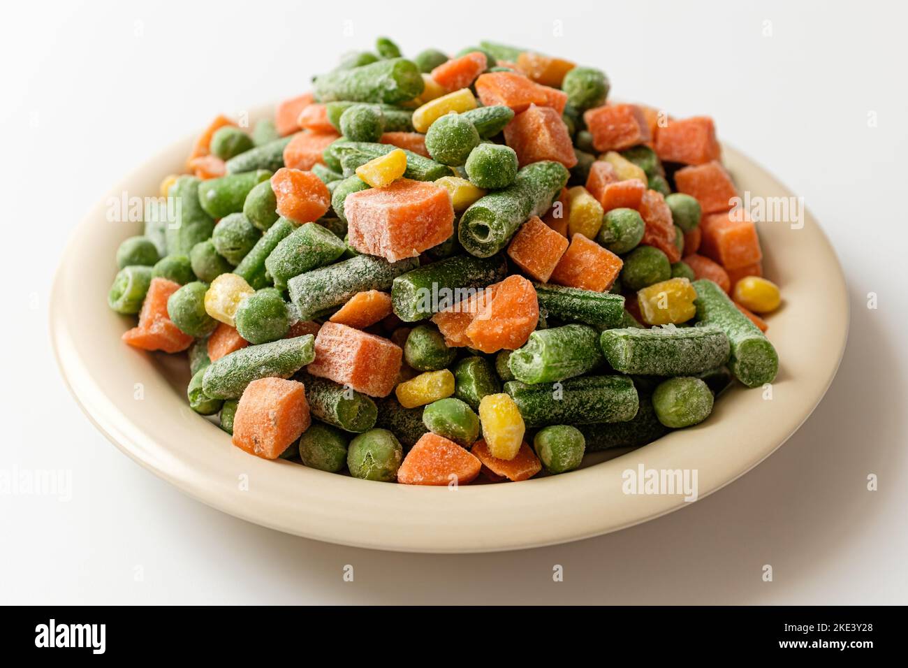 Frozen mixed vegetables on a white background Stock Photo - Alamy