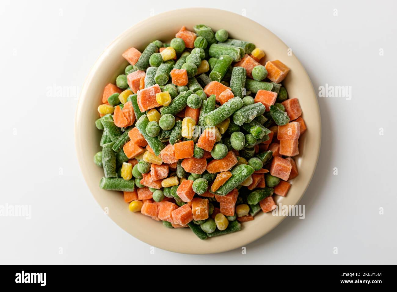 Frozen mixed vegetables on a white background Stock Photo - Alamy