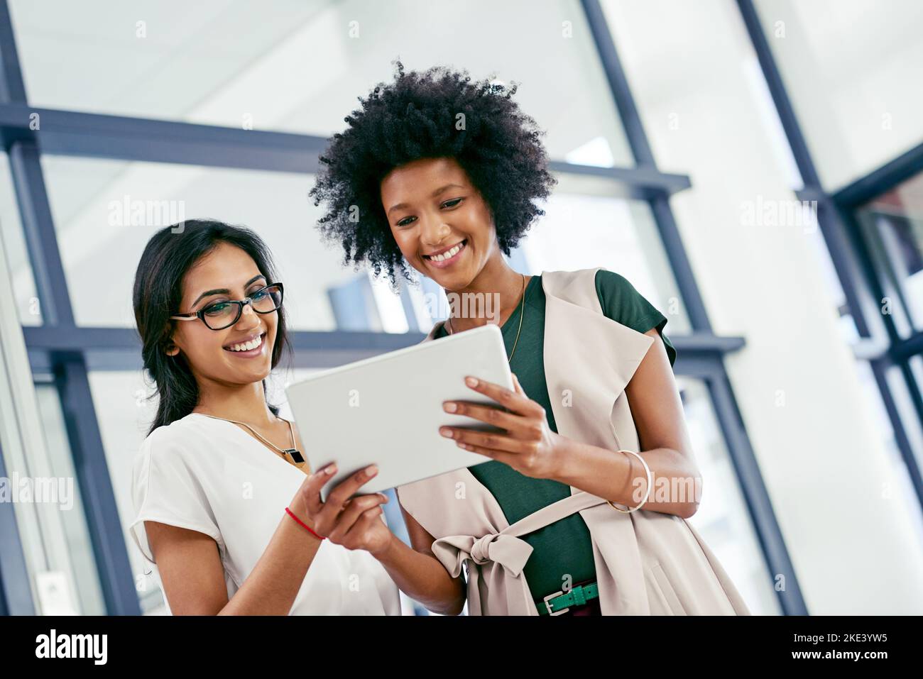 They work best together. two colleagues discussing something on a ...