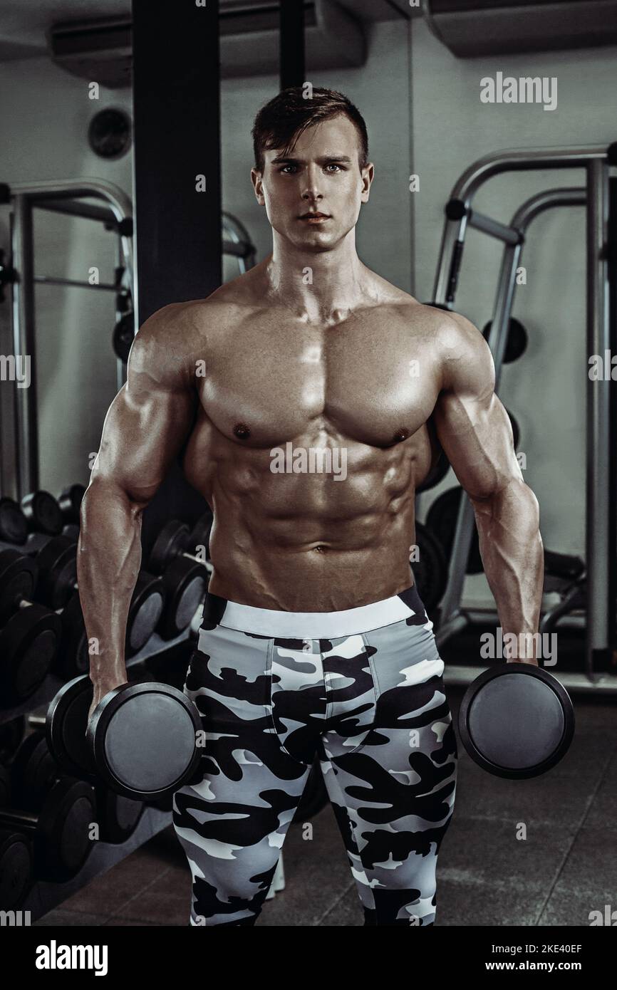 Strong muscular bodybuilder doing exercise in the gym. Part of fitness ...