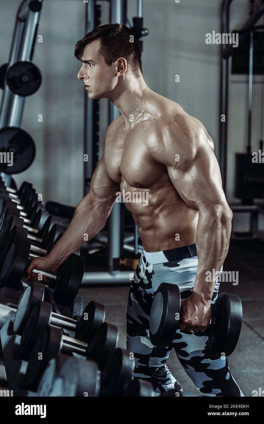 Strong muscular bodybuilder doing exercise in the gym. Part of fitness ...