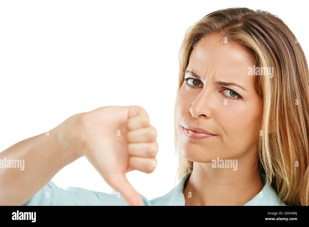 Boo to that idea. an unhappy woman showing a thumbs down against a ...