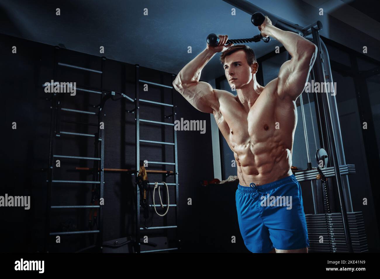 Strong muscular bodybuilder doing exercise in the gym. Part of fitness ...