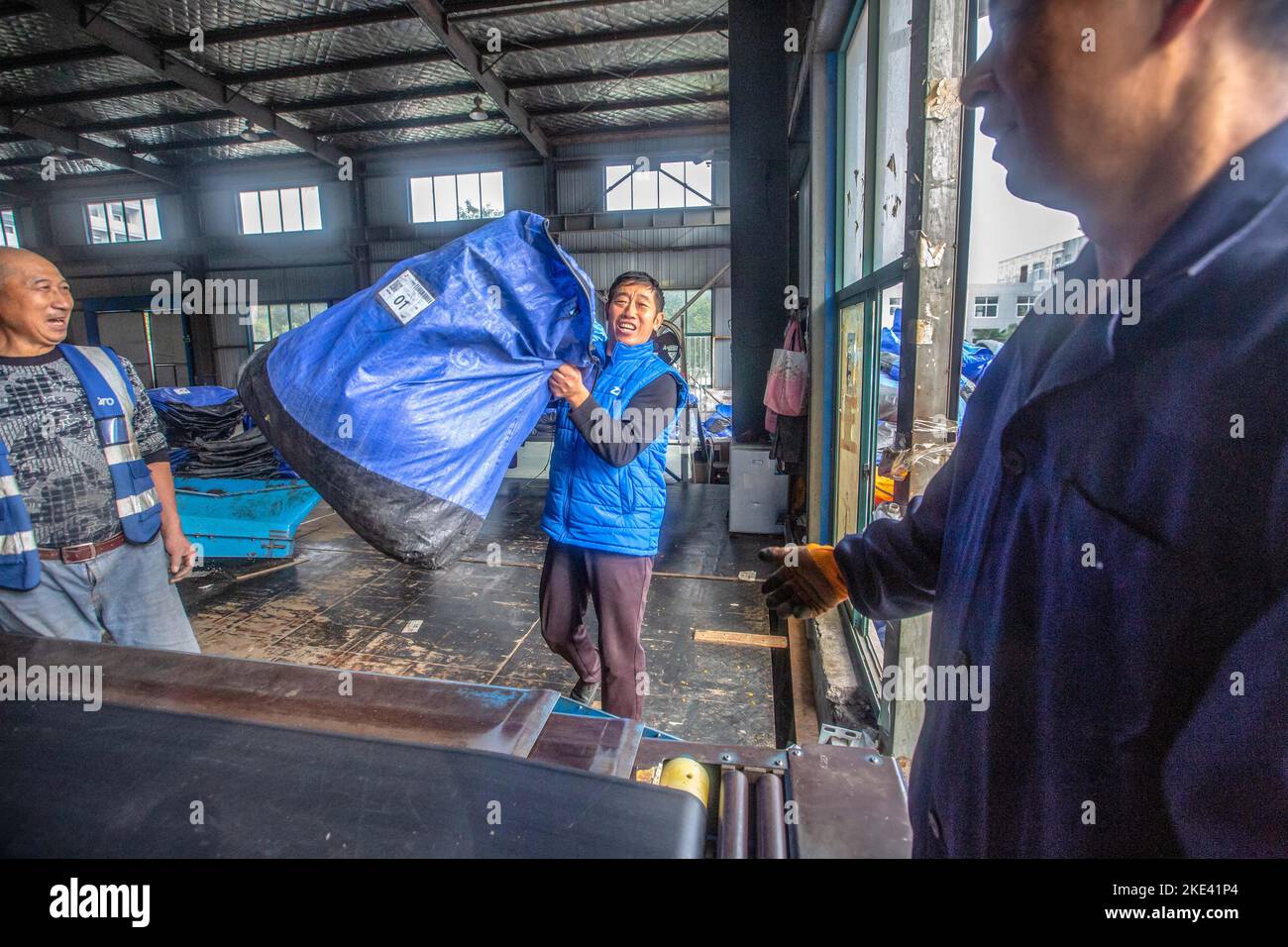 The sorting staff of the express company is working in the workshop in ...