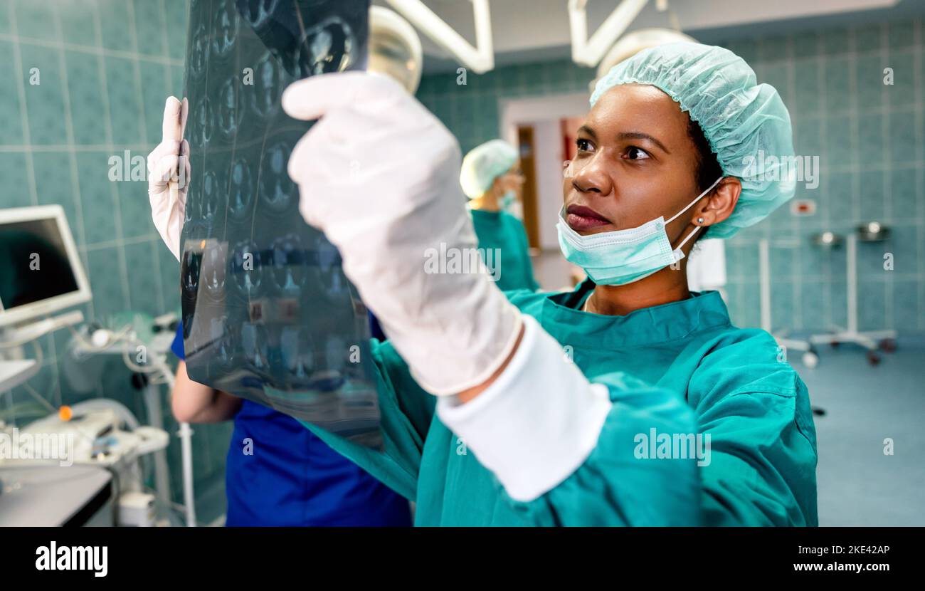 Female doctor looking at ct scan in hospital before surgery Stock Photo ...