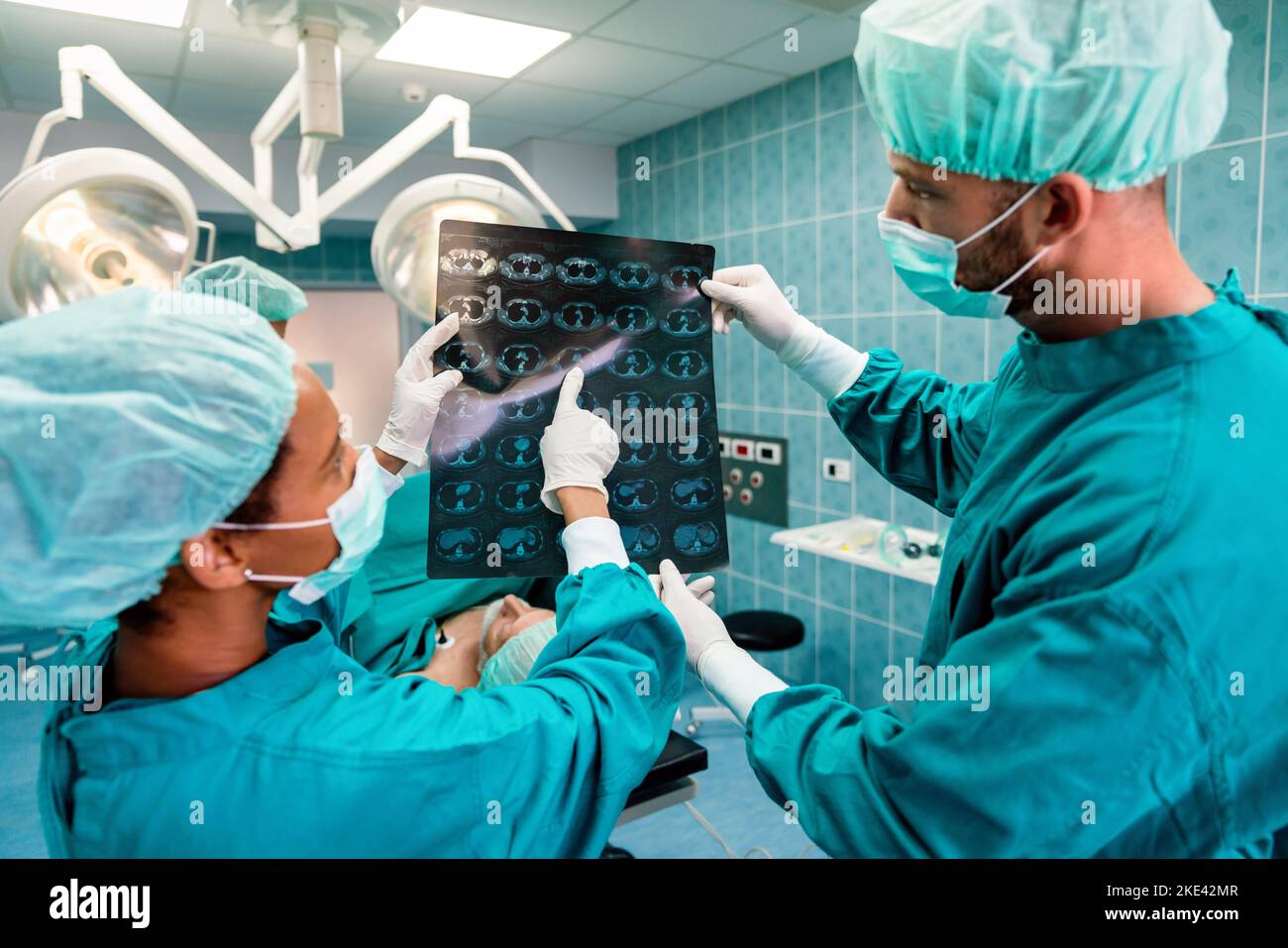 Doctors examining x-ray images of patient for diagnosis. Healthcare ...