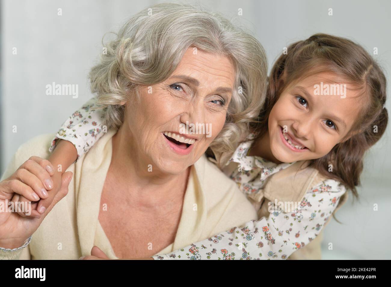 Grandma carrying her granddaughter at her back Stock Photo - Alamy