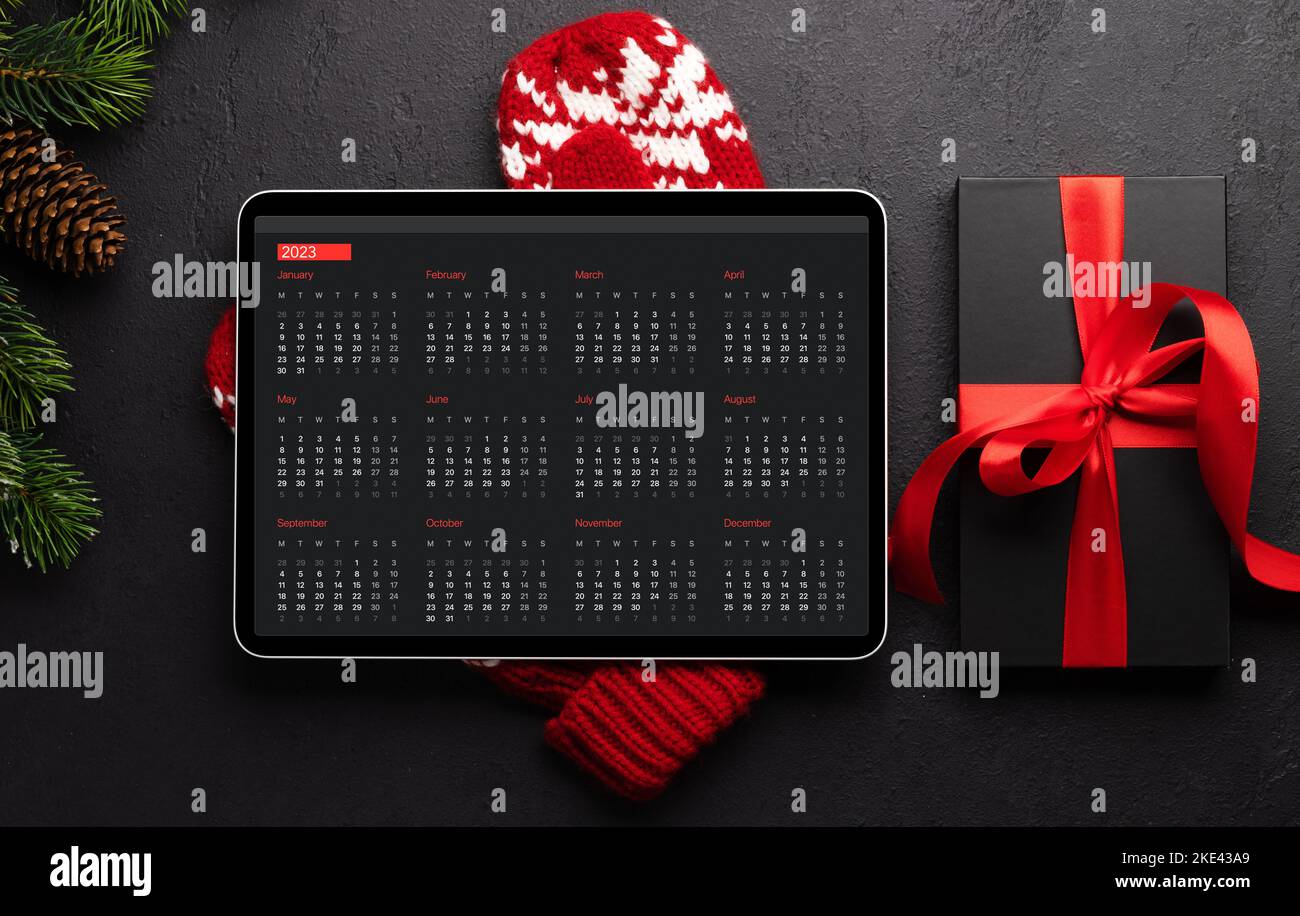 Tablet with calendar, gift box and Christmas decor. Xmas device screen ...