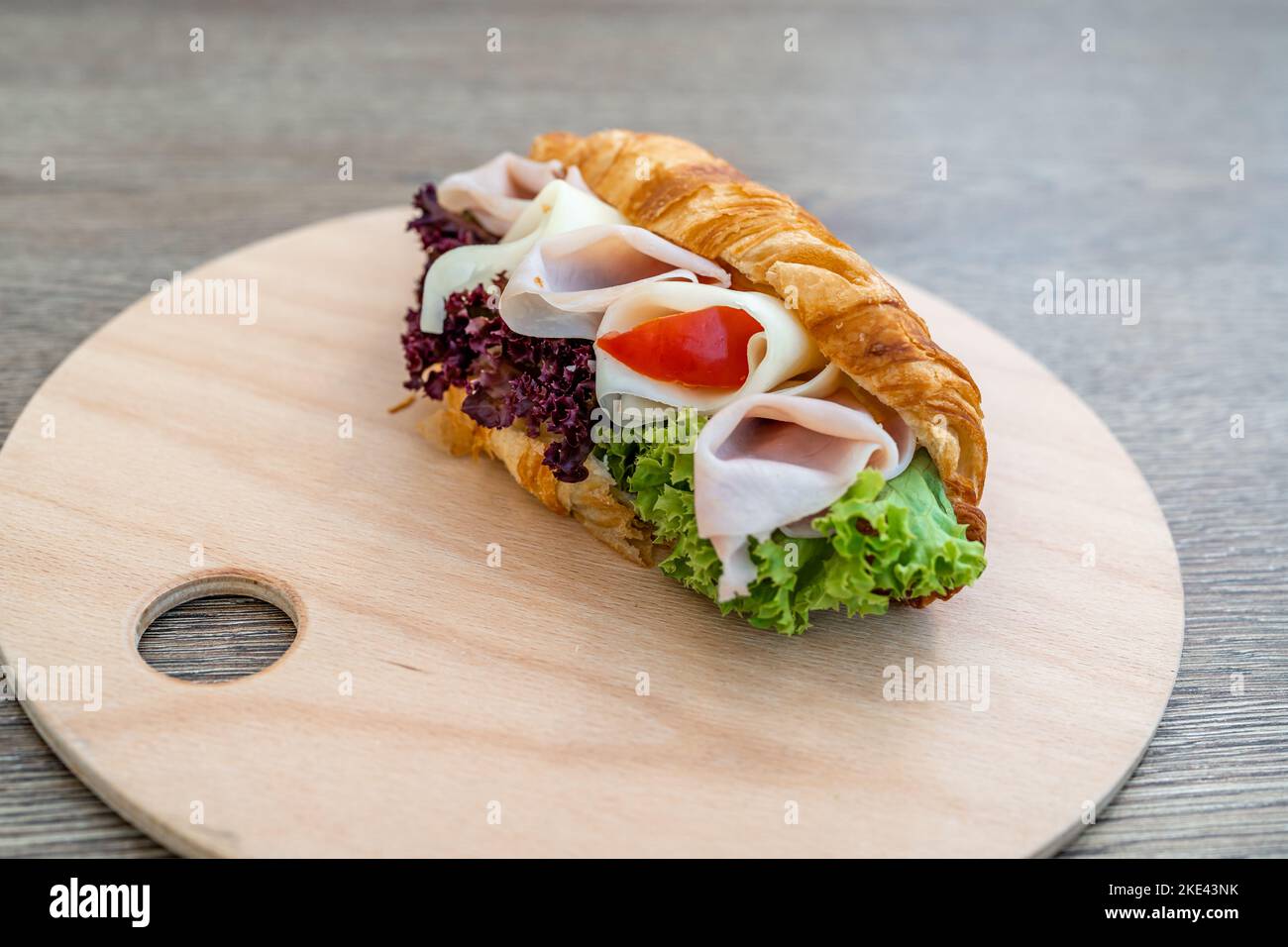 Croissant filled with ham, cheese and vegetables Stock Photo - Alamy
