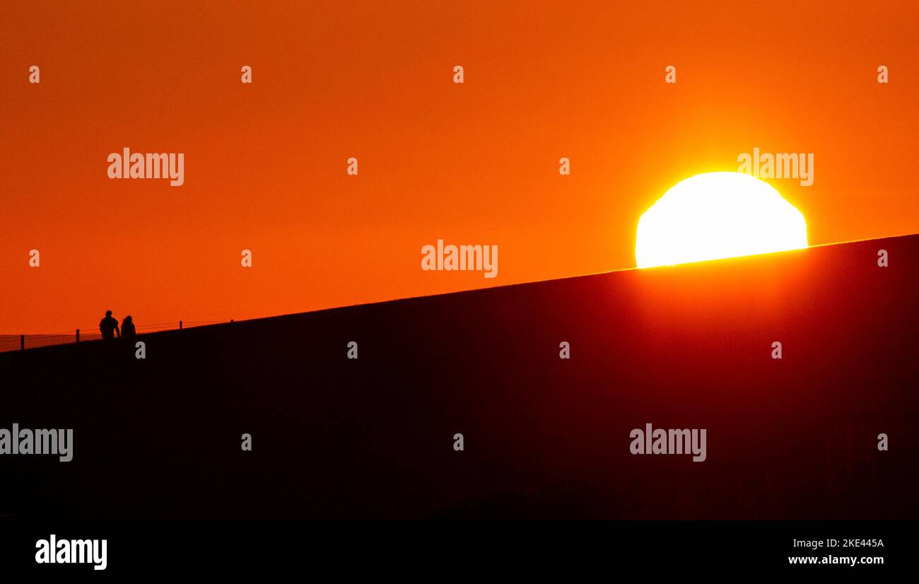 People watch the sunset from the South, West Coastal Path near Mawgan ...