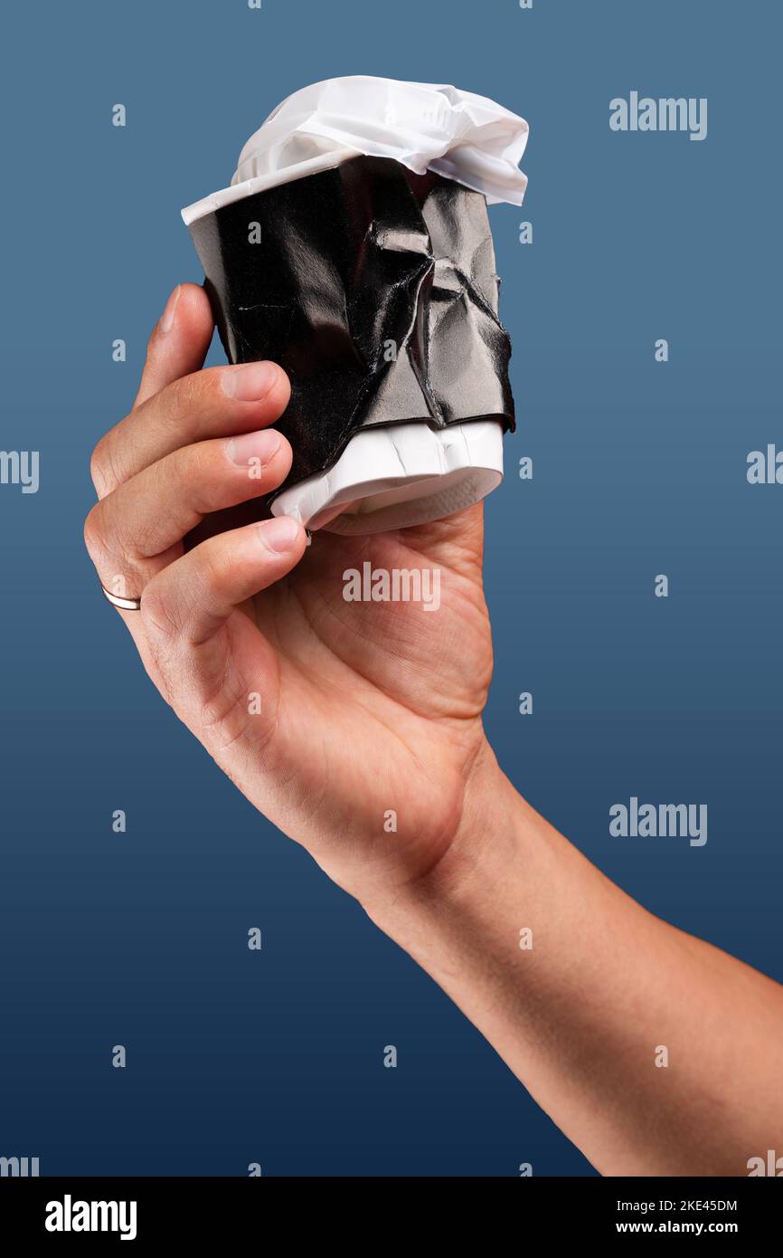 Male hand holds, raised black crumpled paper cup of tea or coffee Stock ...