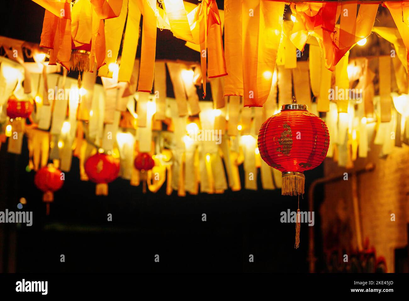 Chinese paper red lanterns hang with garlands of ribbons and lamps at ...