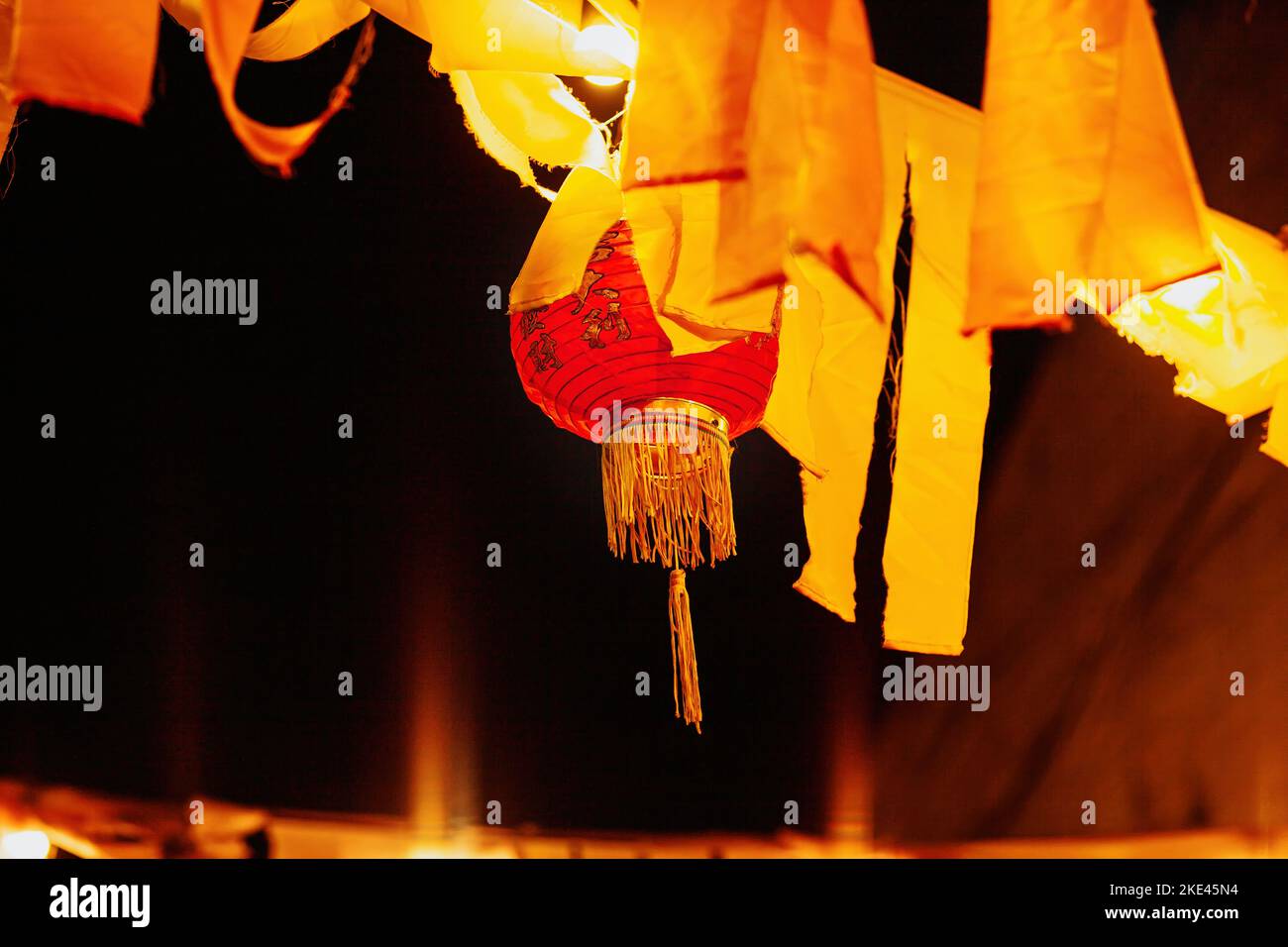 Chinese paper red lanterns hang with garlands of ribbons and lamps at ...