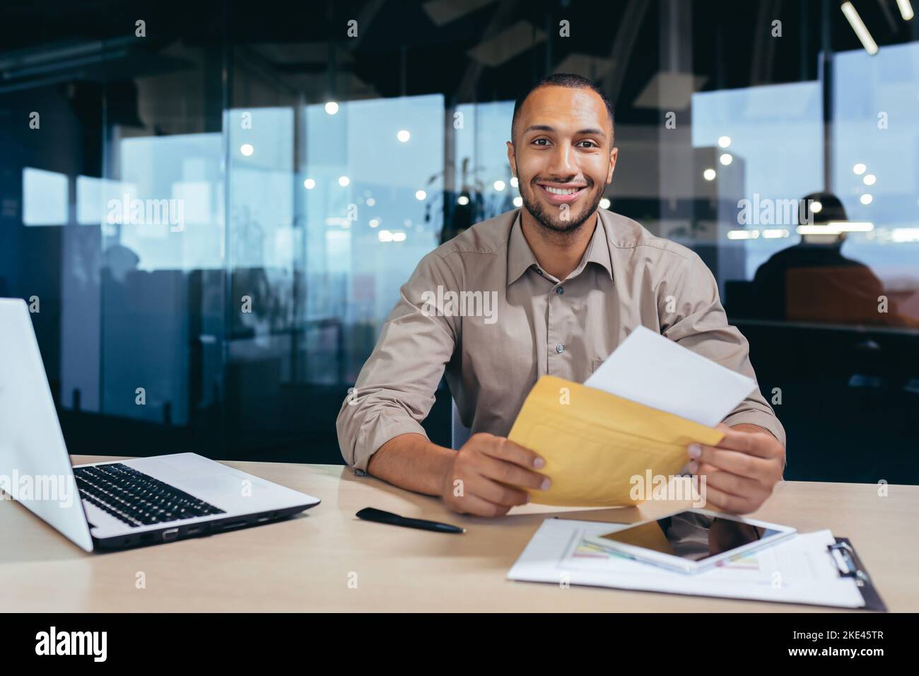 Portrait of happy african american man in office doing paperwork, man ...