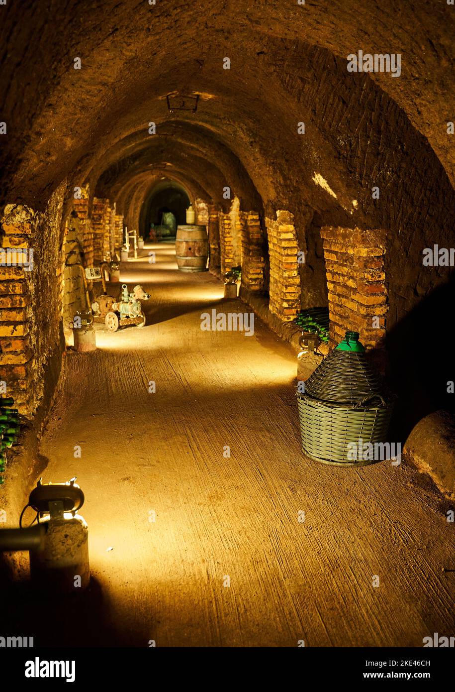 A vertical shot of an underground tunnel with lights and storage ...