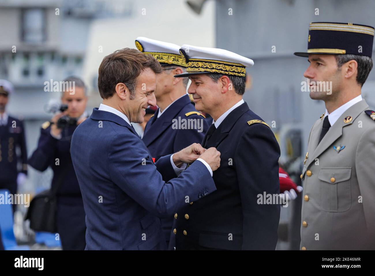 French President Emmanuel Macron decorates soldiers from the deck of ...