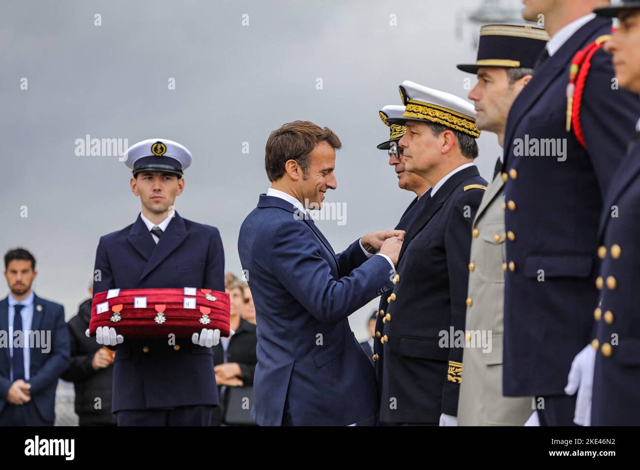 French President Emmanuel Macron decorates soldiers from the deck of ...