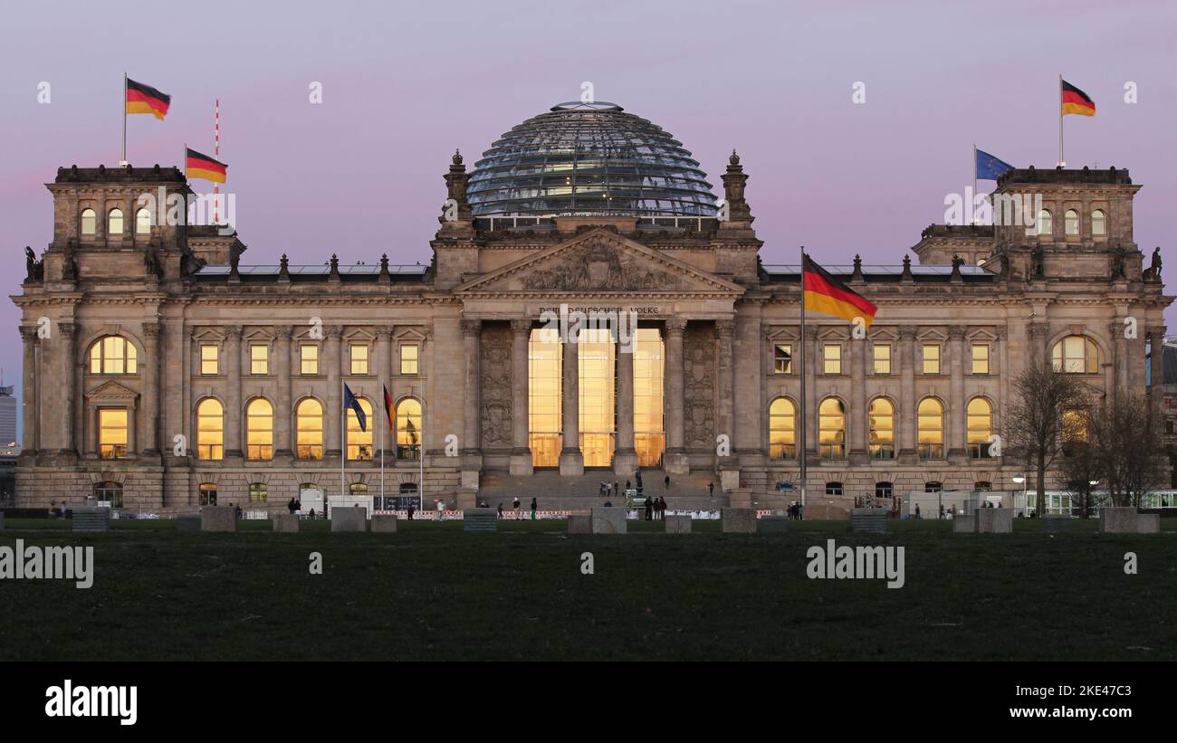 The beautiful Bundestag building with the german flags against the ...