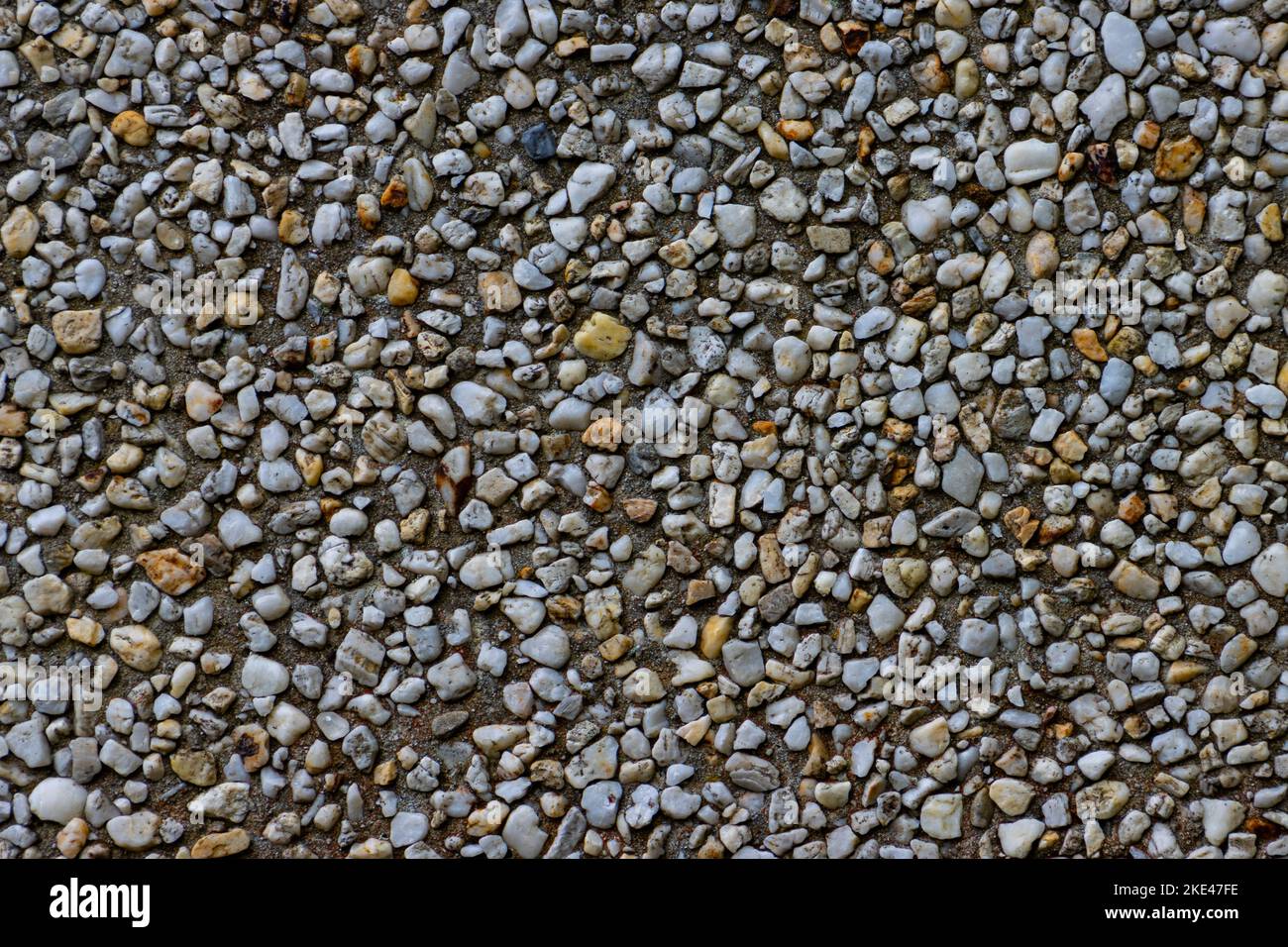 Small pebbles in concrete wall for background Stock Photo - Alamy