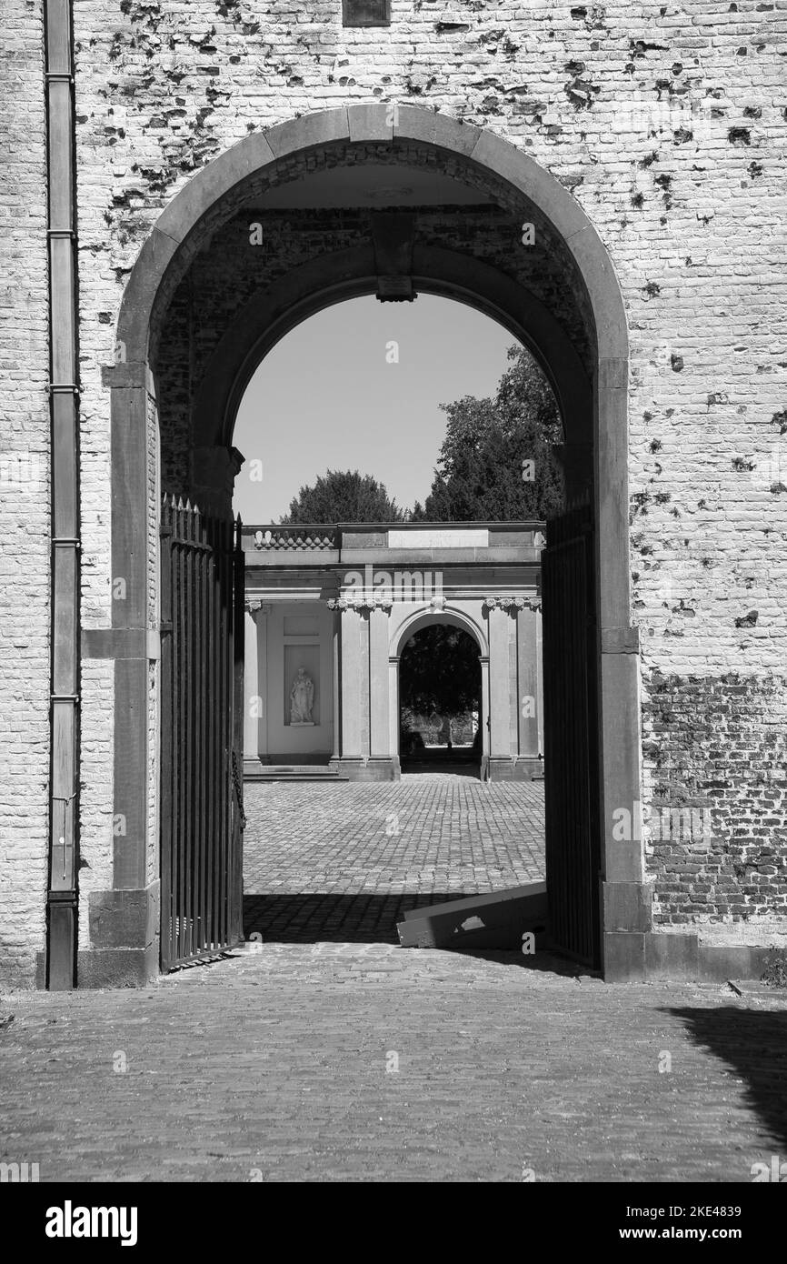 A vertical grayscale view of the inner courtyard of castle of Seneffe ...