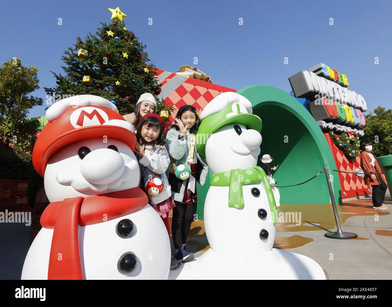 Visitors pose at Universal Studios Japan's "Super Nintendo World," an ...