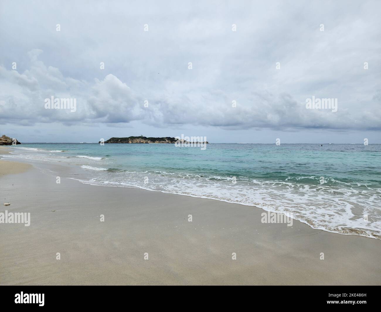 A calm seashore washed by the waters of transparent and clear water ...