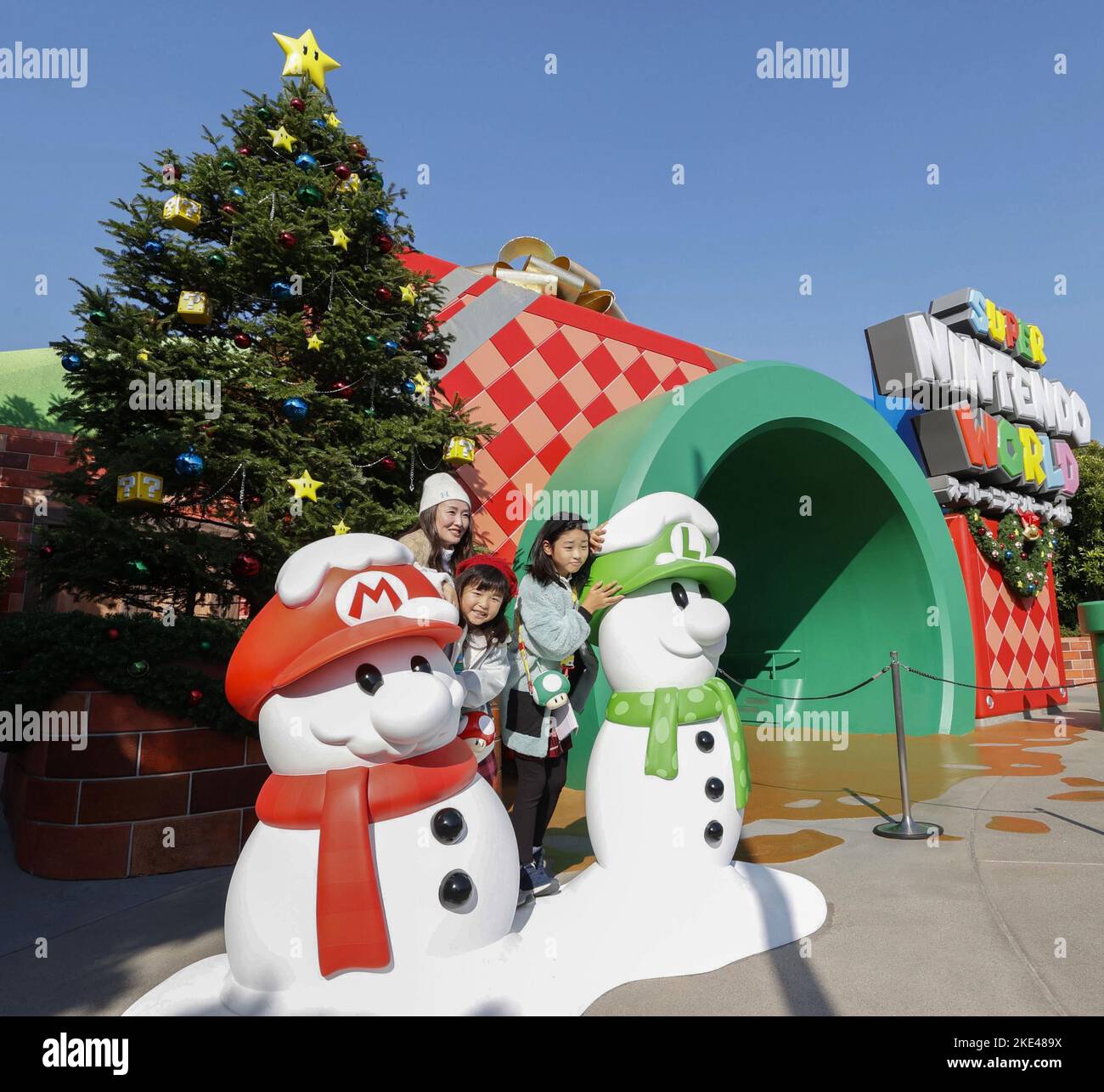 Visitors pose at Universal Studios Japan's "Super Nintendo World," an ...