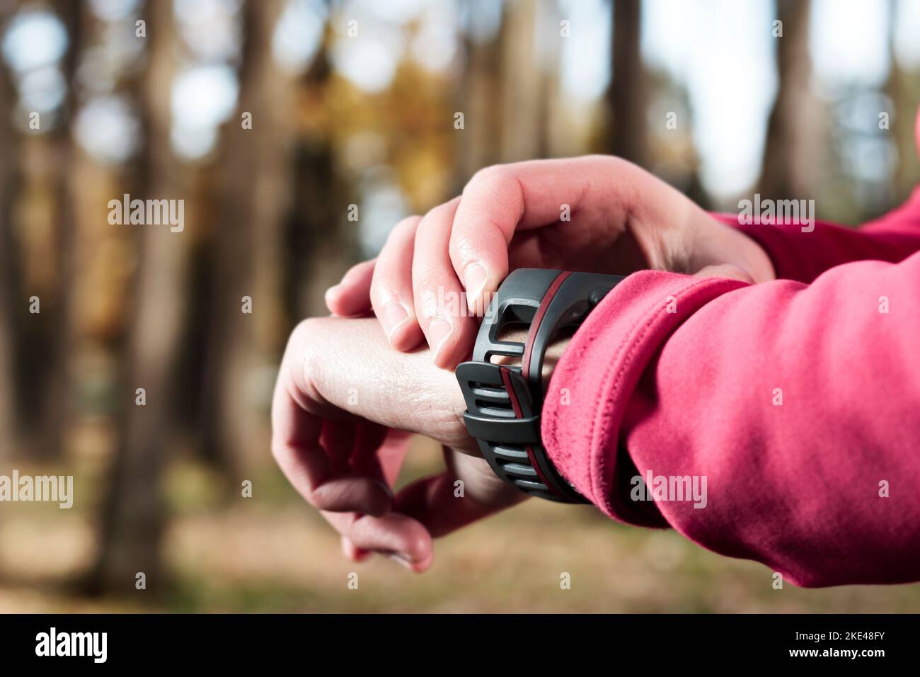 Young woman setting her GPS heart rate monitor before a workout Stock ...