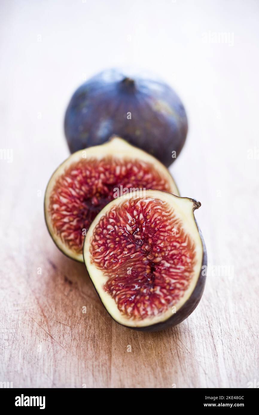 Three pieces of fig on a wood plank with selective focus Stock Photo ...