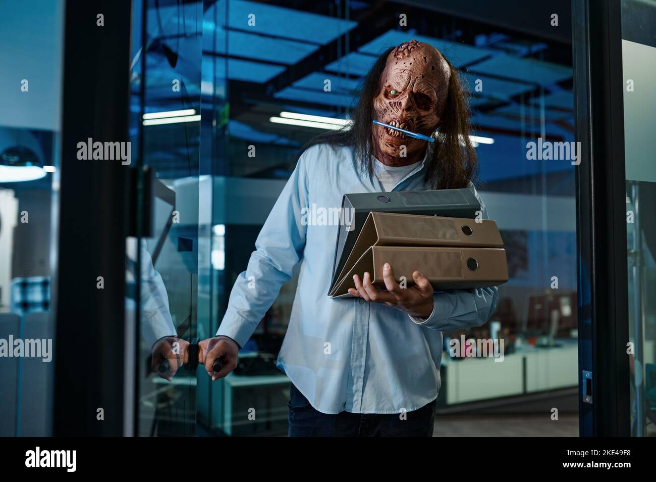 Zombie employee carrying folder binder stack on office Stock Photo - Alamy