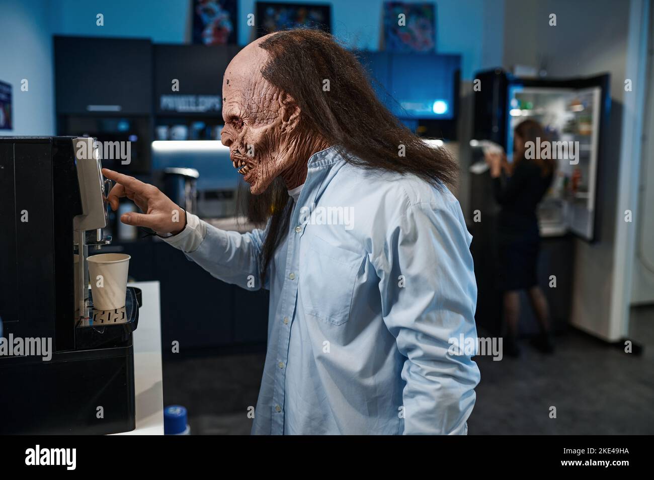 Zombie worker making coffee using vending machine Stock Photo - Alamy