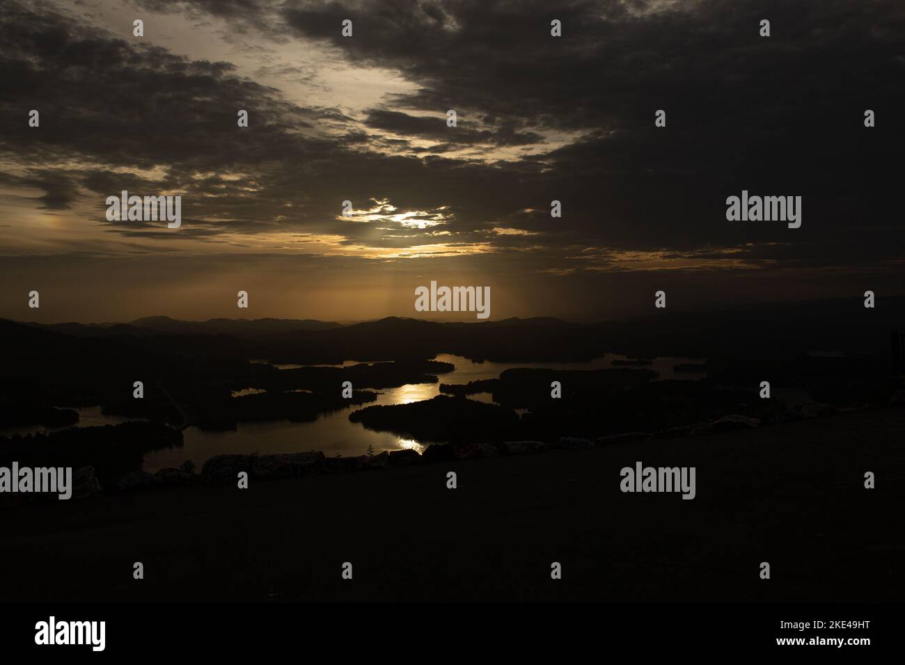 An aerial view of a curved river, illuminated by sun rays during the ...