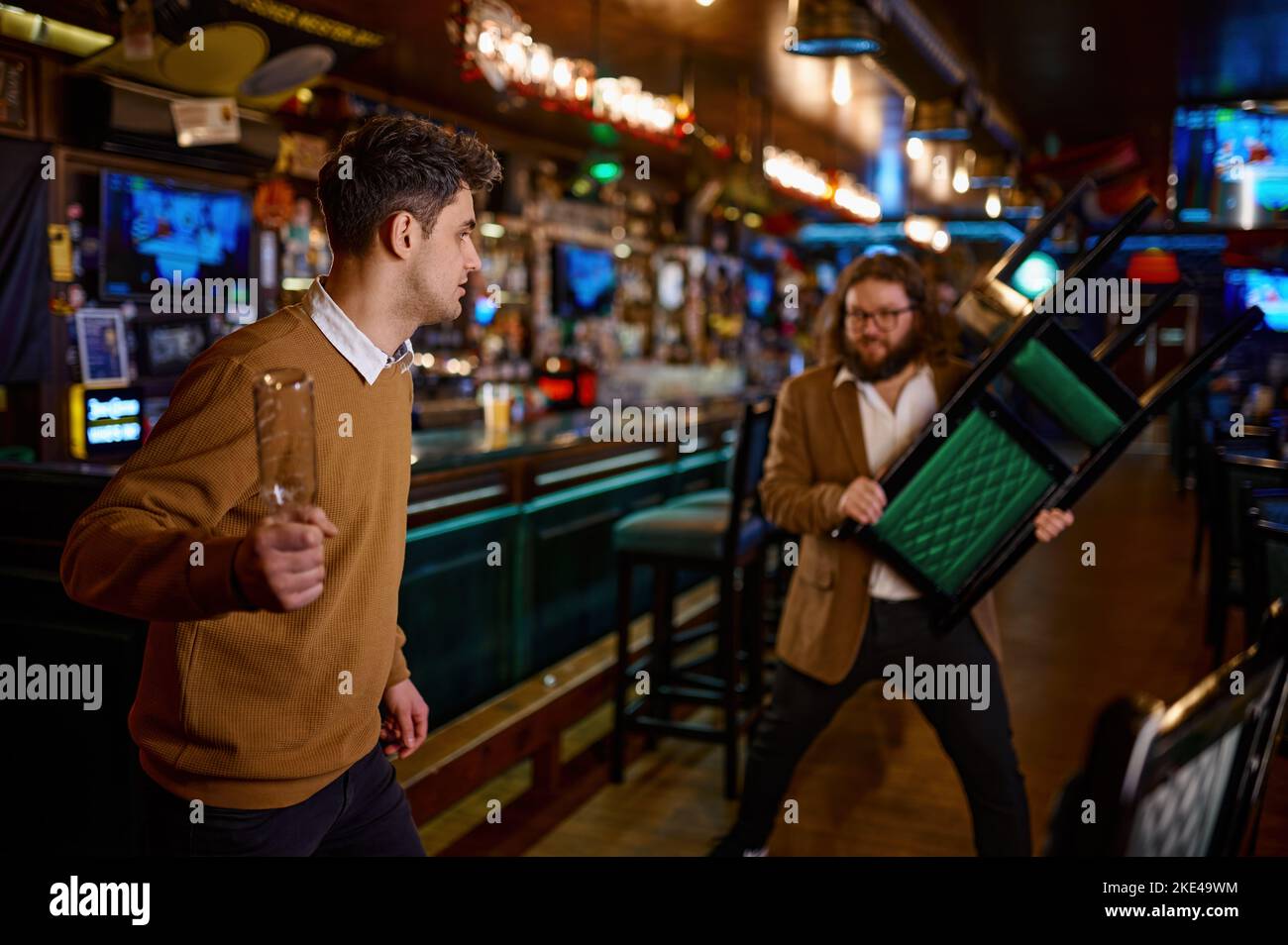 Two man hooligan football team fans get in bar fight Stock Photo - Alamy