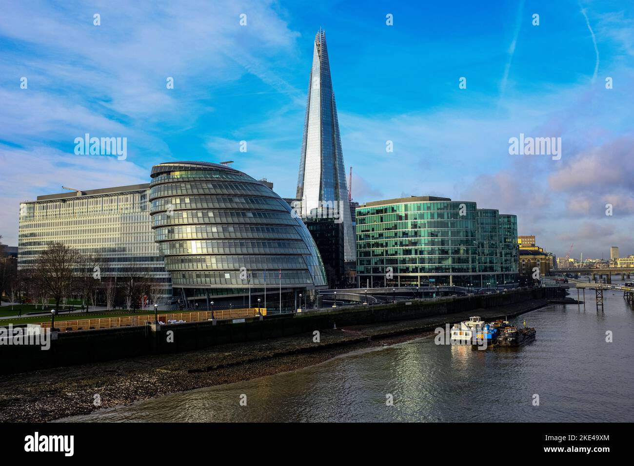 The London Thames and the Shard behind City Hall against a blue sky ...