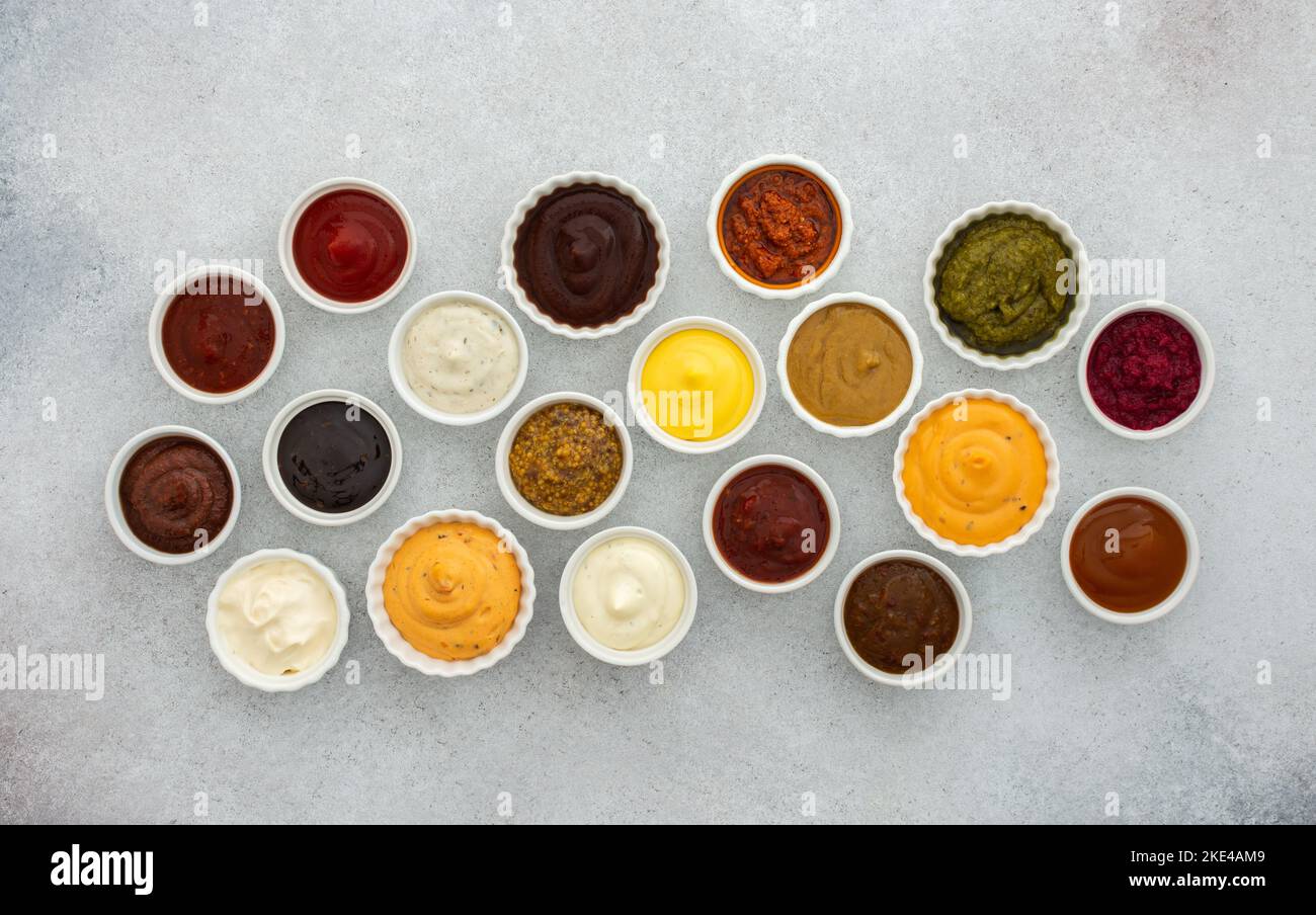 Different types of sauces in bowls , ketchup and mayonnaise, pesto and ...