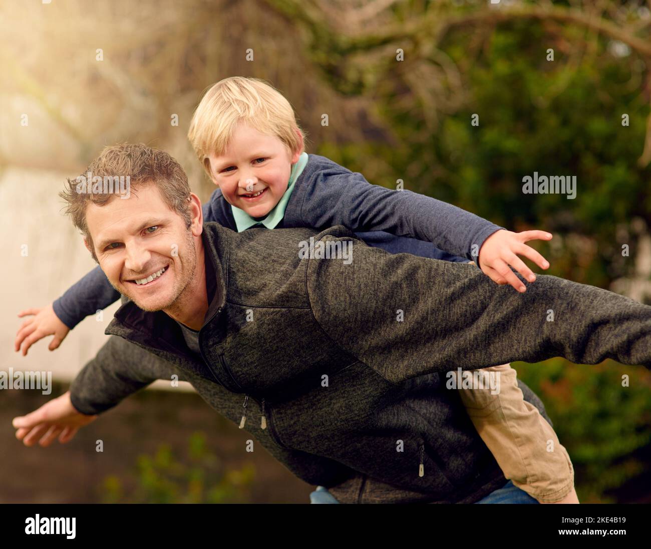 Its a bird, its a plane...Portrait of a father playing with his little ...