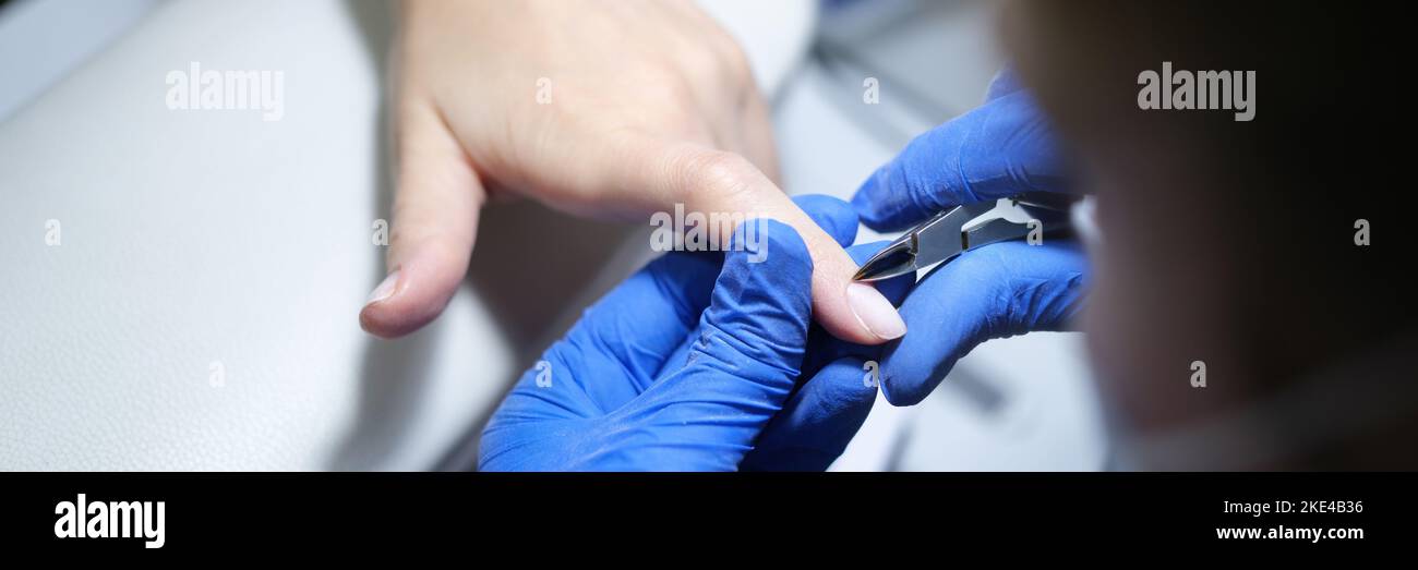 Cuticle for milling female nails. Manicurist girl uses scissors Stock ...
