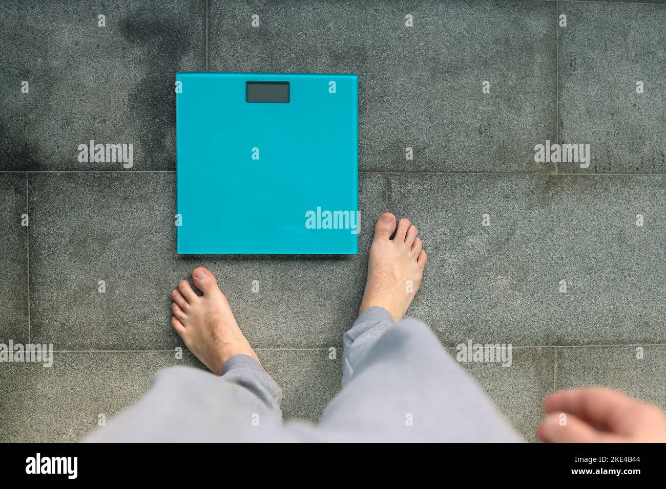 Man standing on weight scale. Male feet on glass scales, men's diet ...