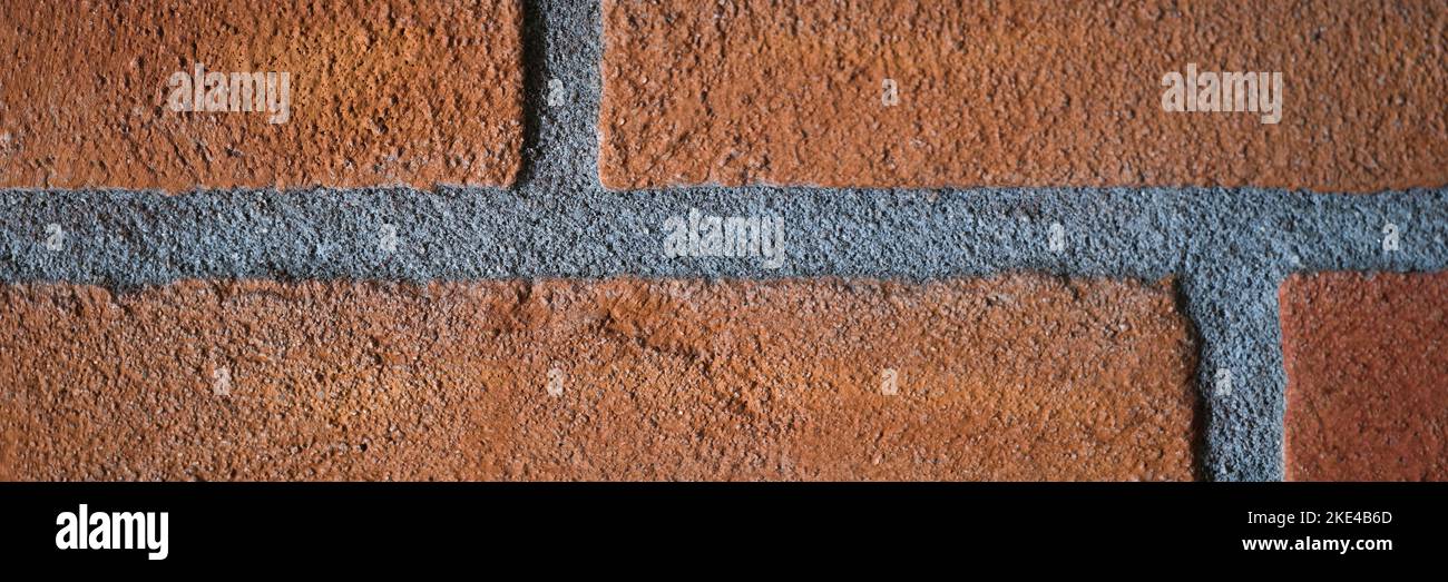 Wall painting of rough red brick with seams Stock Photo - Alamy