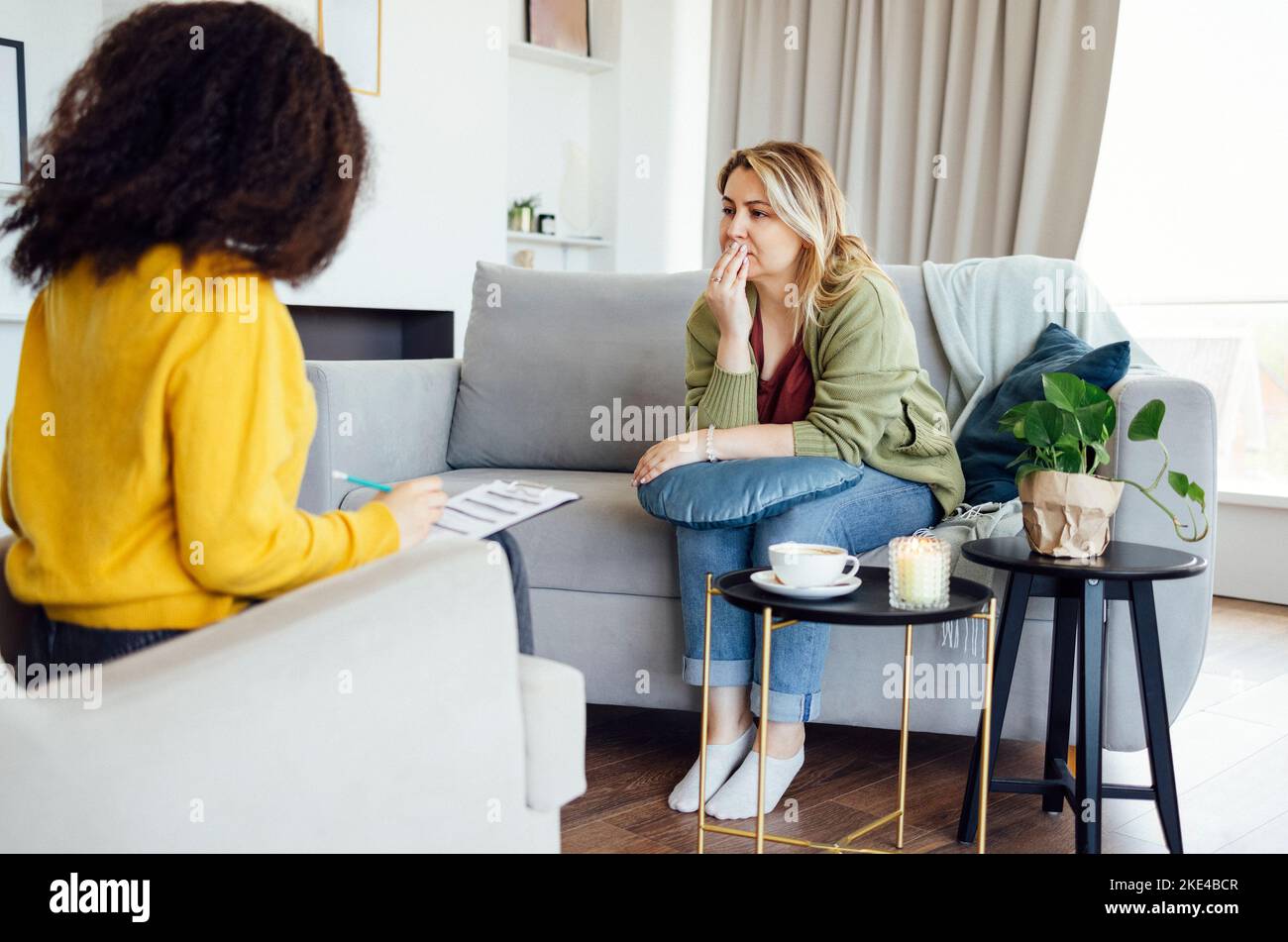 Female African American psychotherapist offering female middle age ...