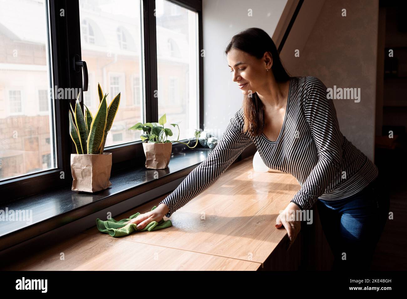 Cleaning the home table disinfecting the kitchen table surface with a ...