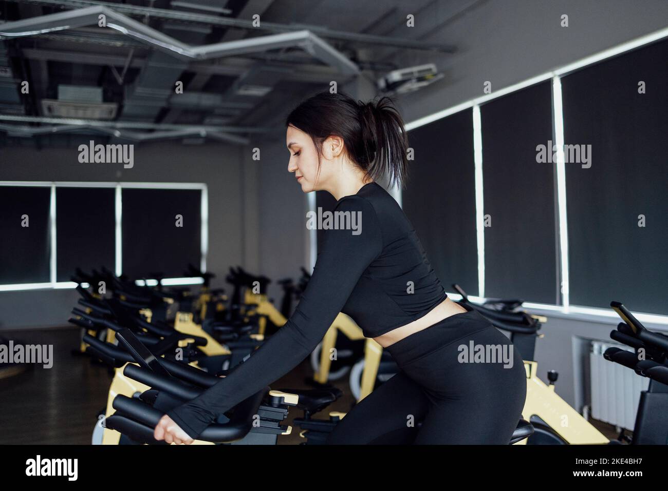 Beautiful woman doing her daily fitness excercises on stationary ...